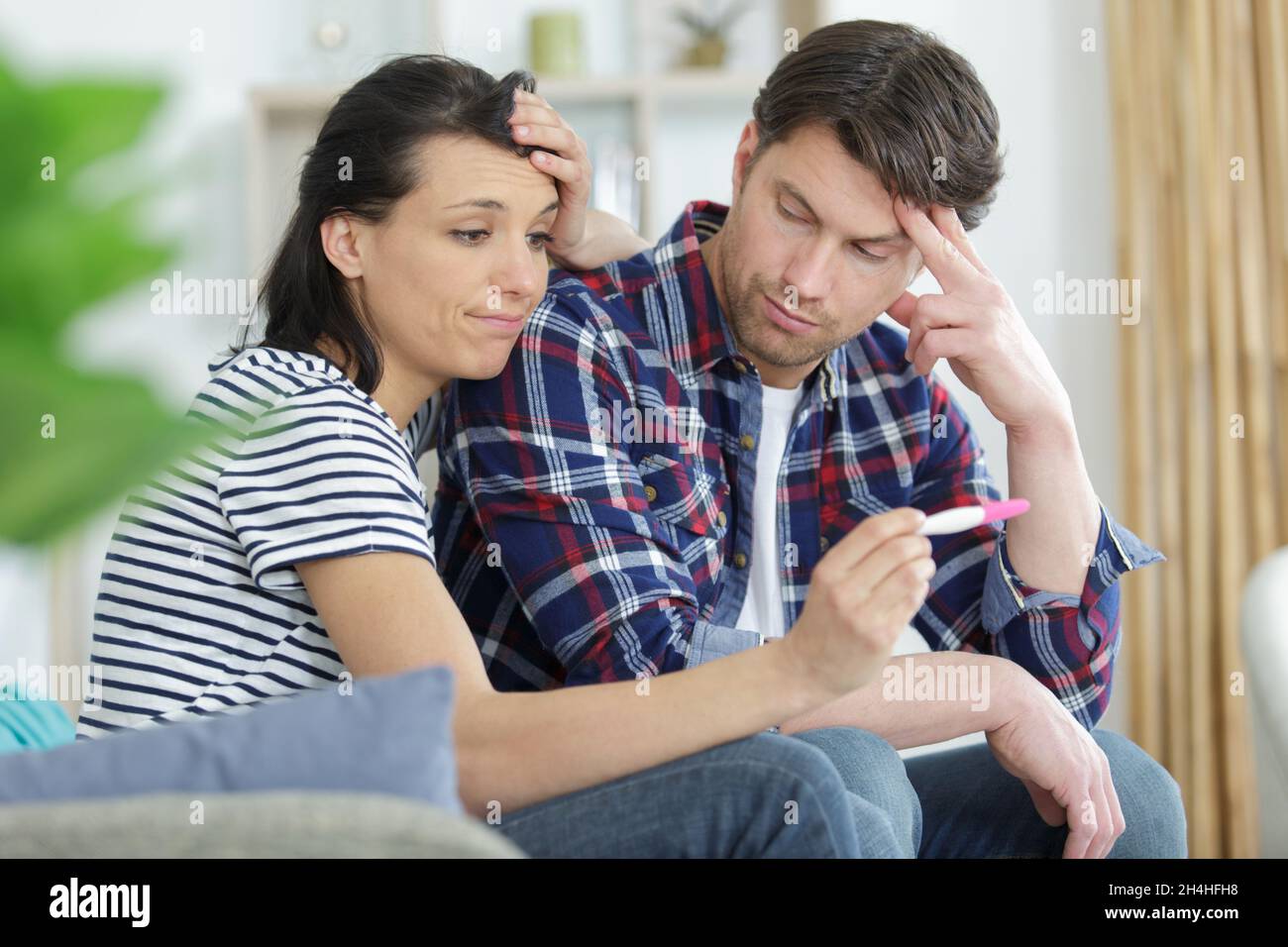 disappointed couple looking at pregnancy test Stock Photo - Alamy