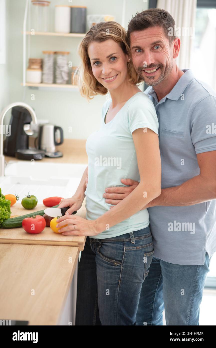couple hugging in kitchen couple Stock Photo - Alamy