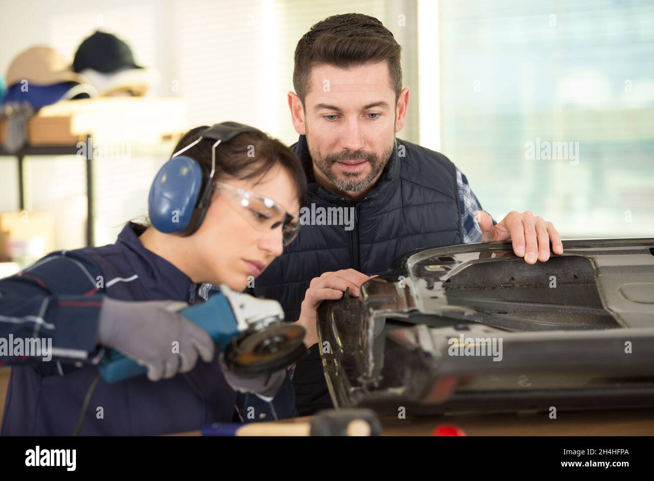 female apprentice in training to use an angle grinder Stock Photo - Alamy