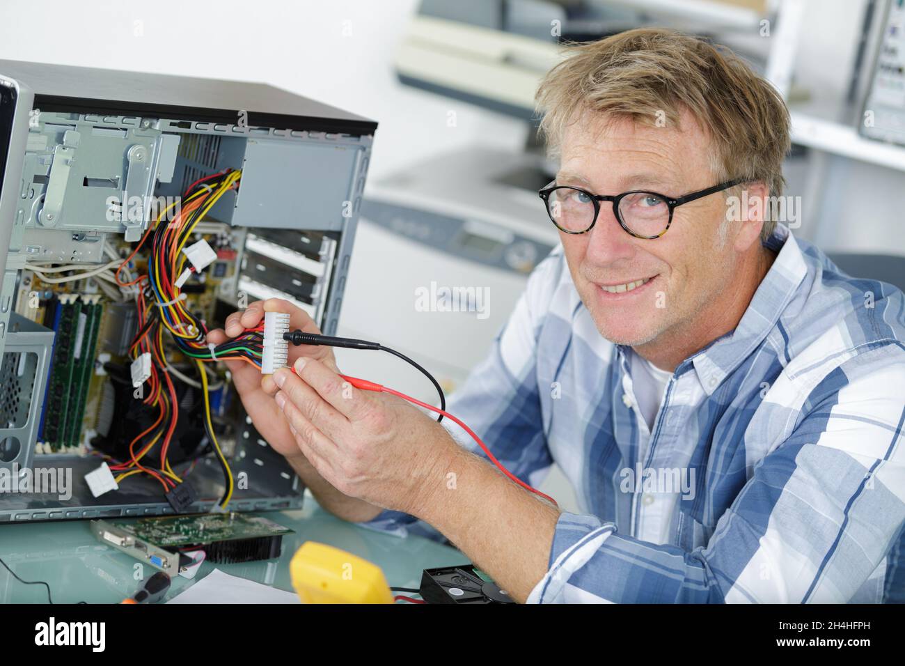 mature man using voltage meter on pc Stock Photo - Alamy