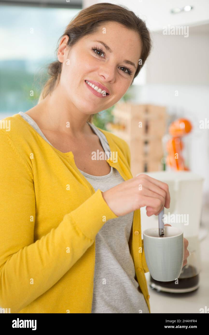 woman stirring coffee in a cup Stock Photo - Alamy