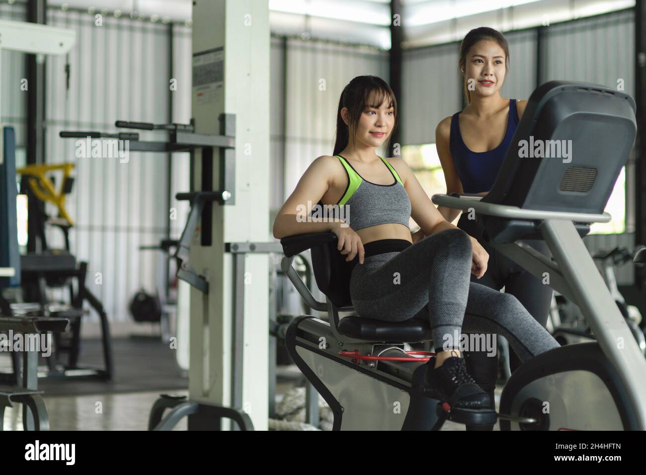 Attractive fit personal trainer mentor coach and teach young female to ...