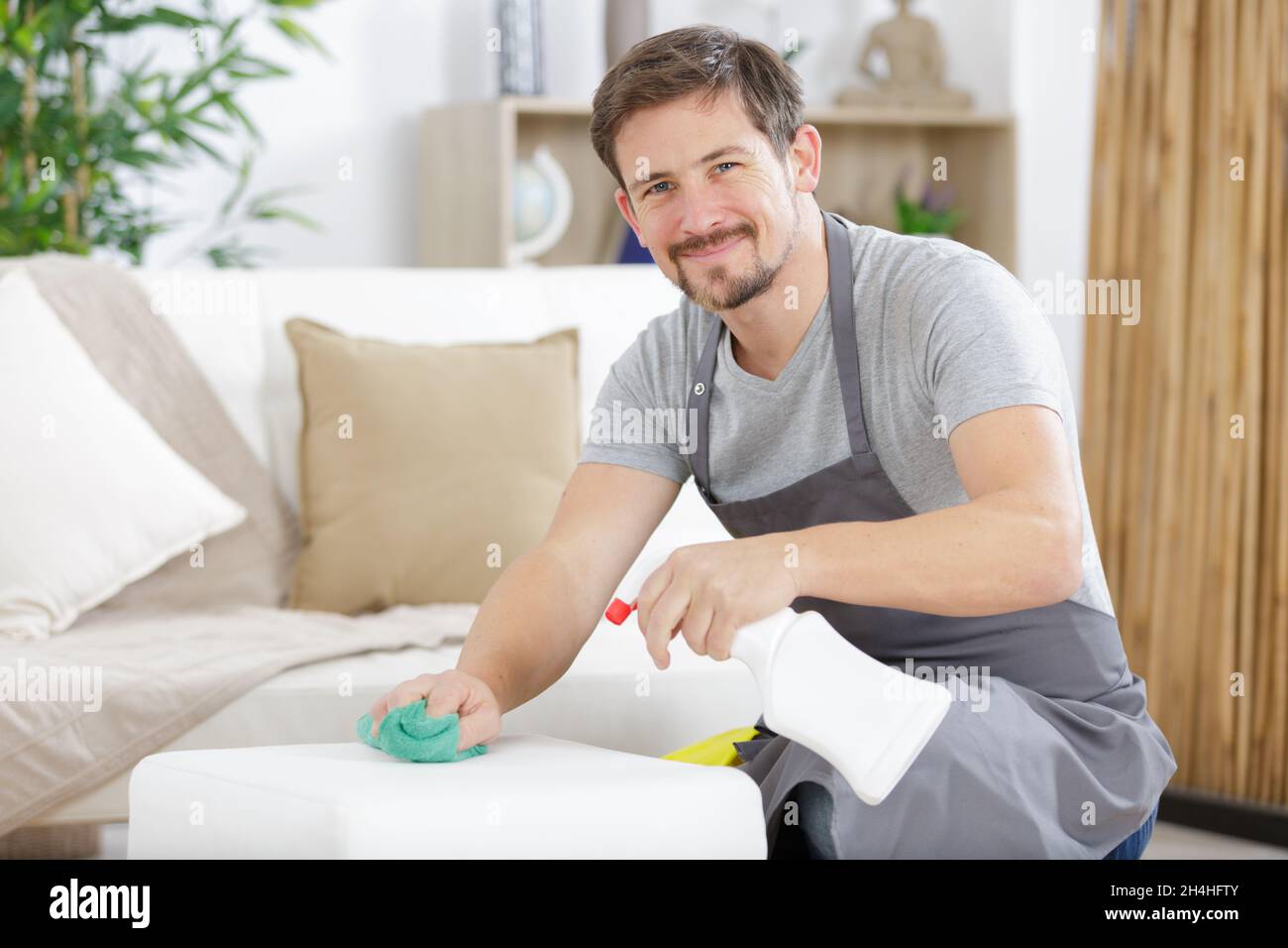 happy man is holding spray Stock Photo - Alamy