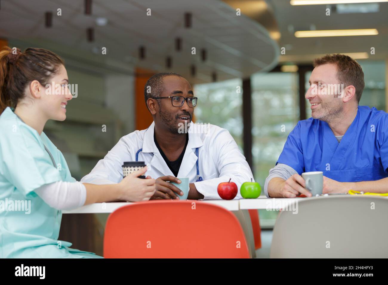 team of doctors having lunch Stock Photo - Alamy