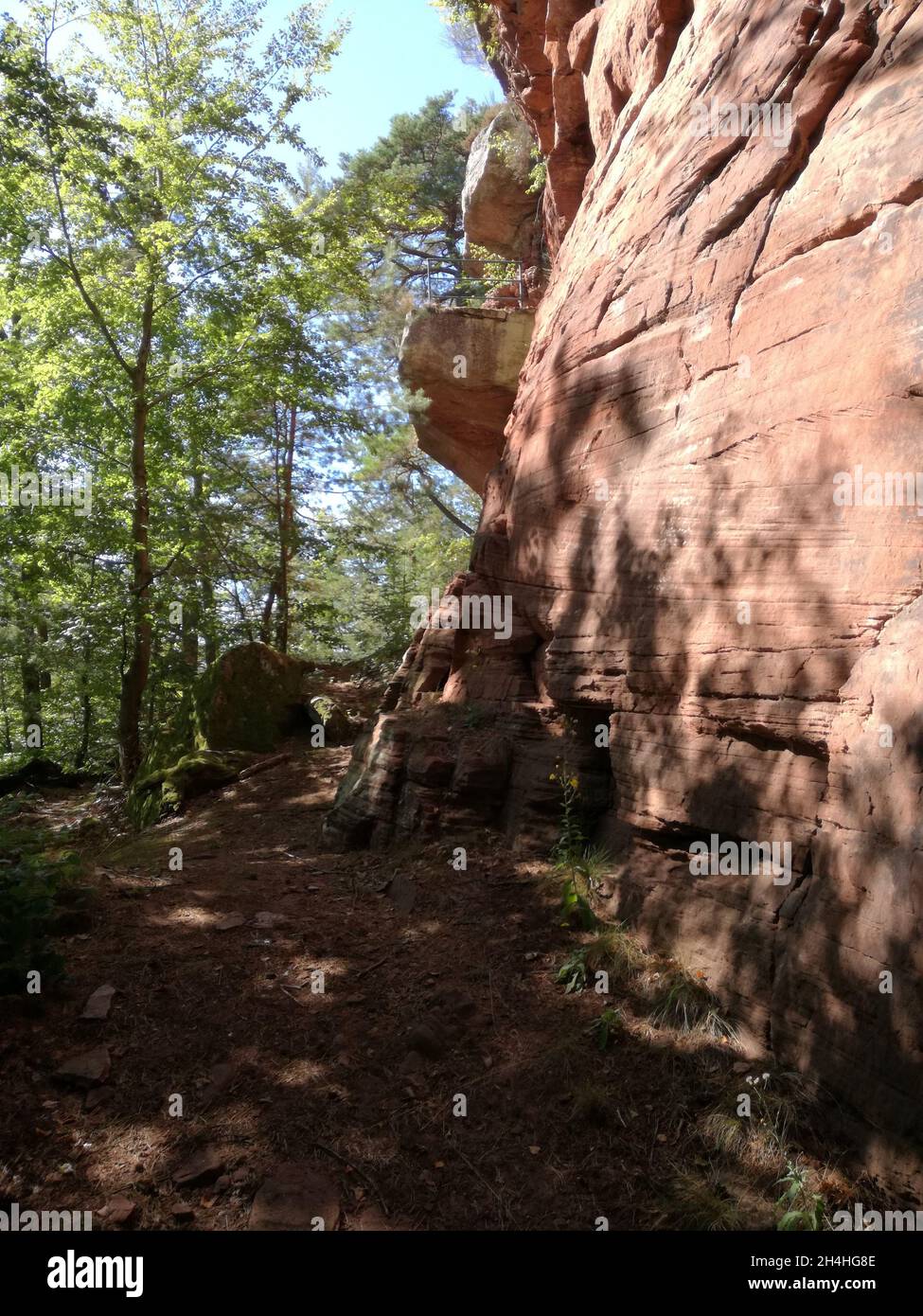 Trail along a large red rock cliff Stock Photo - Alamy