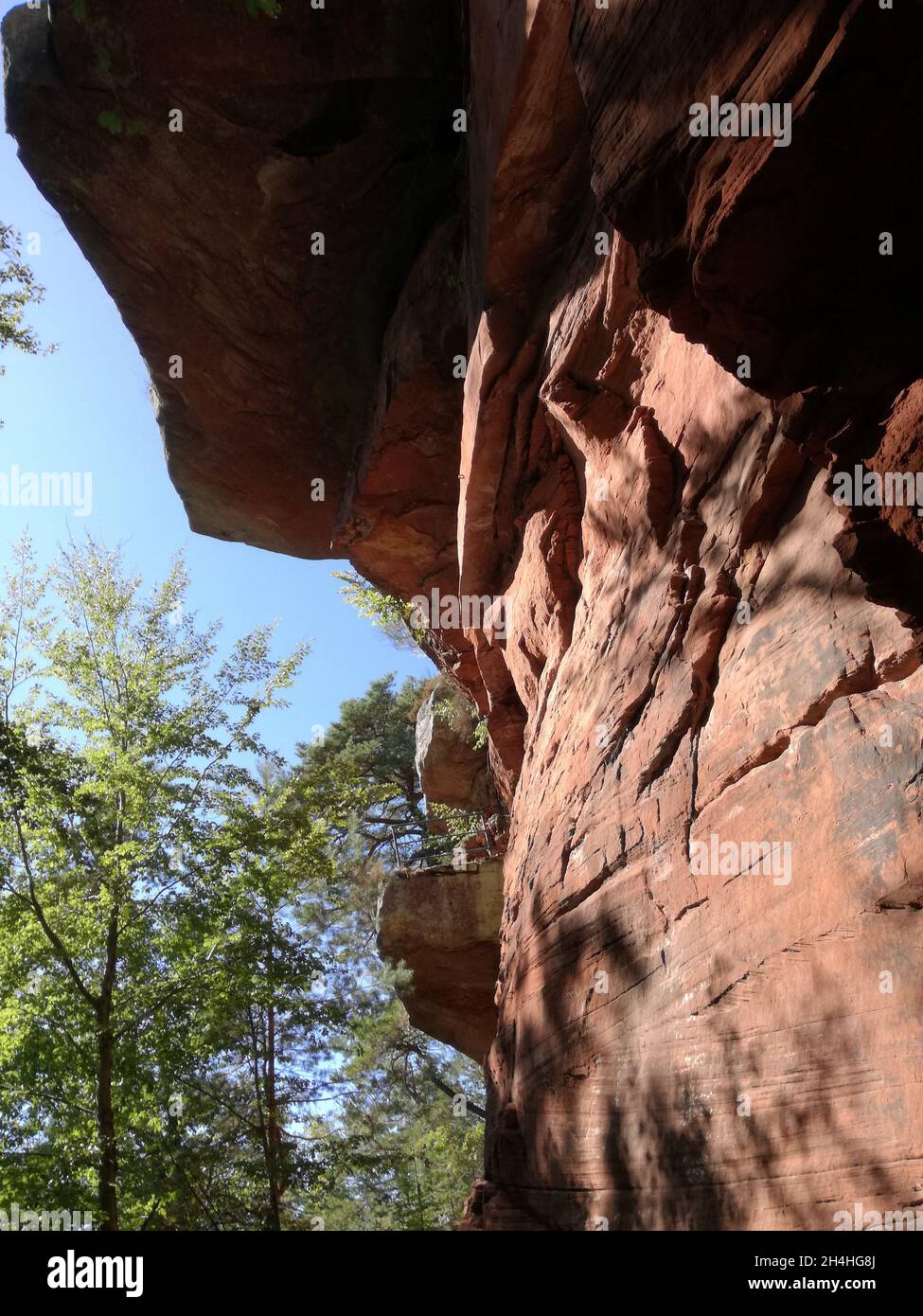 Low angle shot of a large red rock cliff Stock Photo - Alamy
