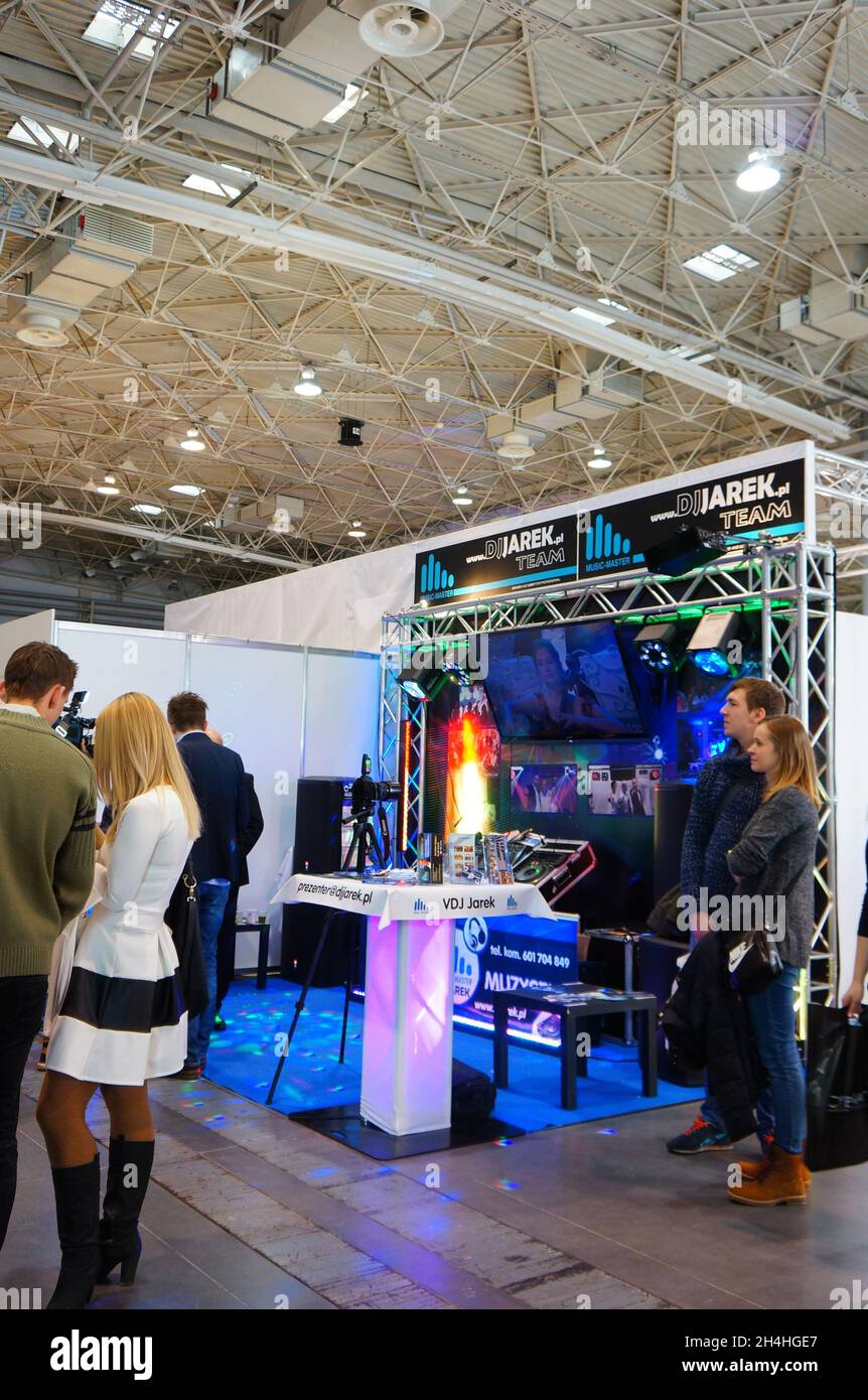 POZNAN, POLAND - Jan 23, 2016: A group of people by a DJ stand at a ...
