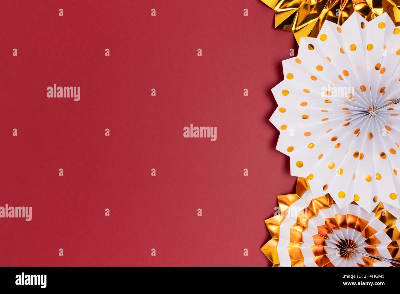 Border frame made of paper fans. White and gold decorations on a red ...
