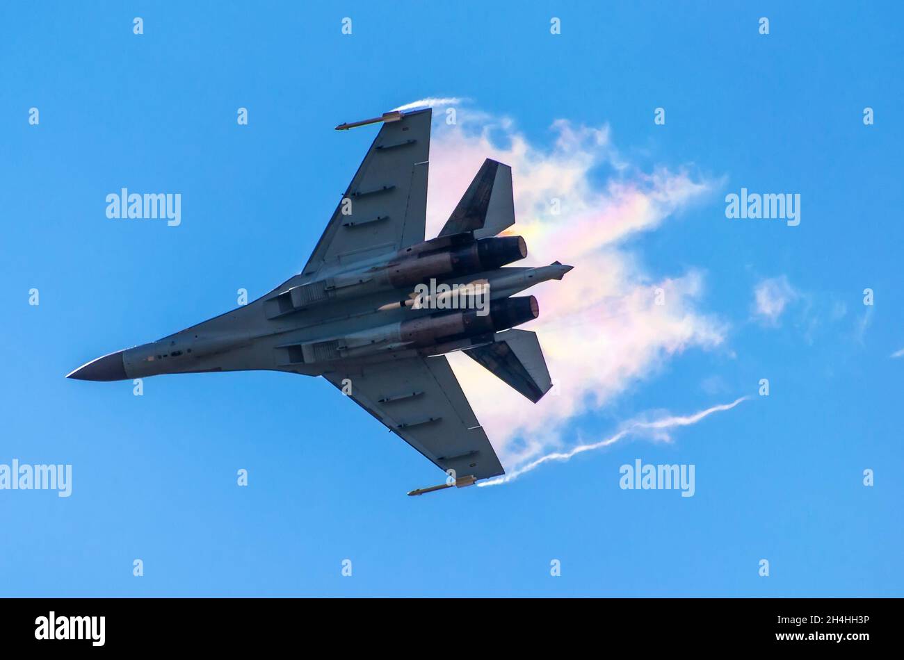 Battle fighter jet flying dives breaking clouds on a blue sky Stock ...