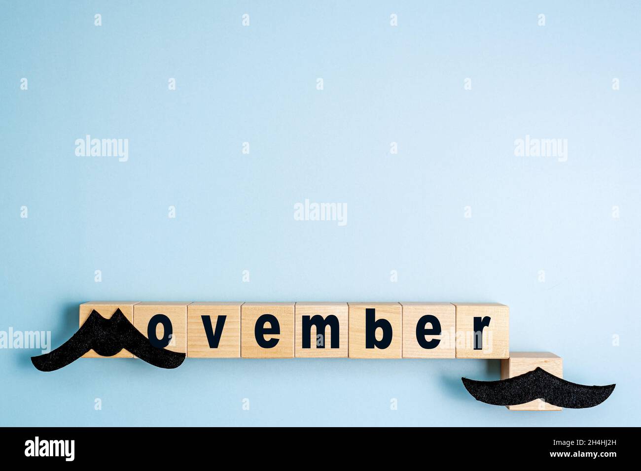 Word MOVEMBER and mustaches on blue background Stock Photo - Alamy