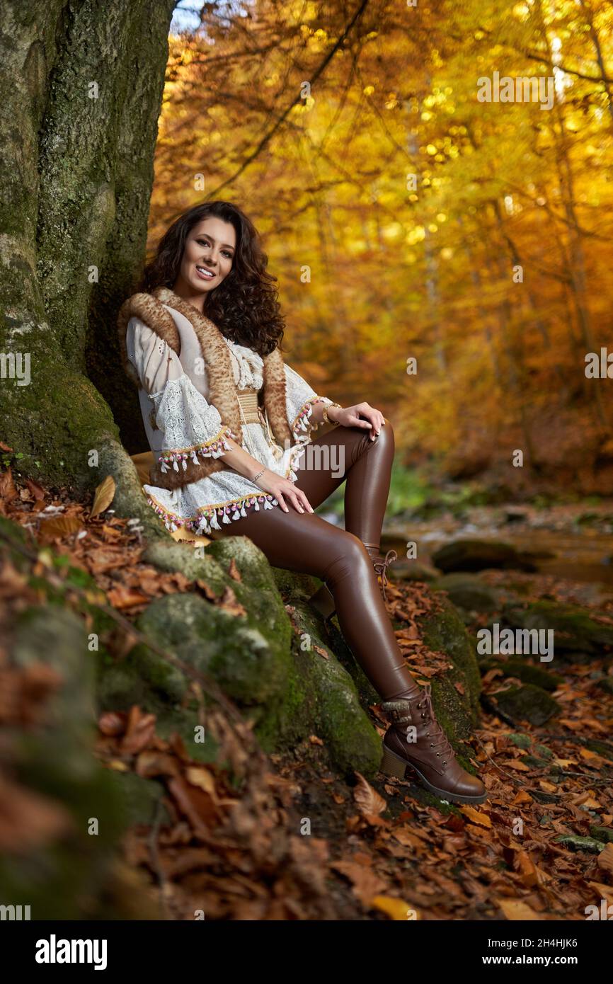 Portrait of a beautiful young woman by the river mid autumn Stock Photo ...