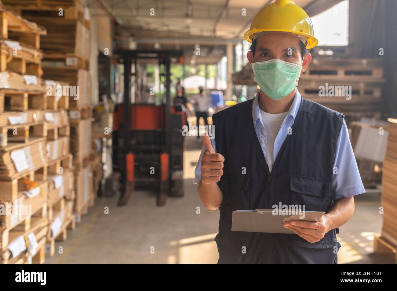 Worker checking raw material inventory in factory Stock Photo - Alamy