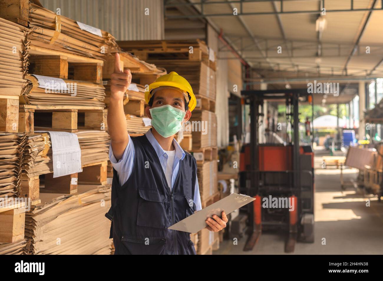 Worker checking raw material inventory in factory Stock Photo - Alamy