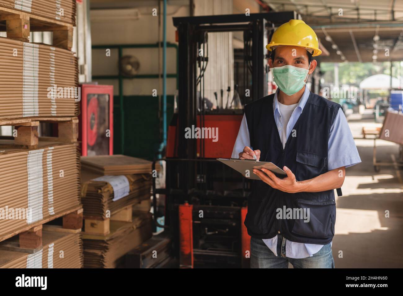 Worker checking raw material inventory in factory Stock Photo - Alamy