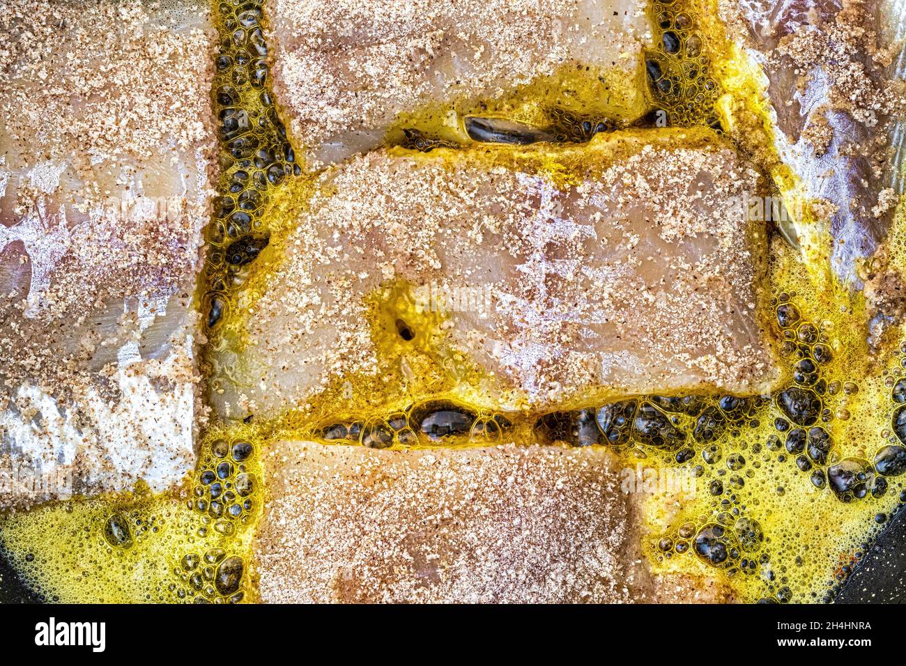 Breaded white fish steaks, fried in a pan with vegetable oil Stock ...