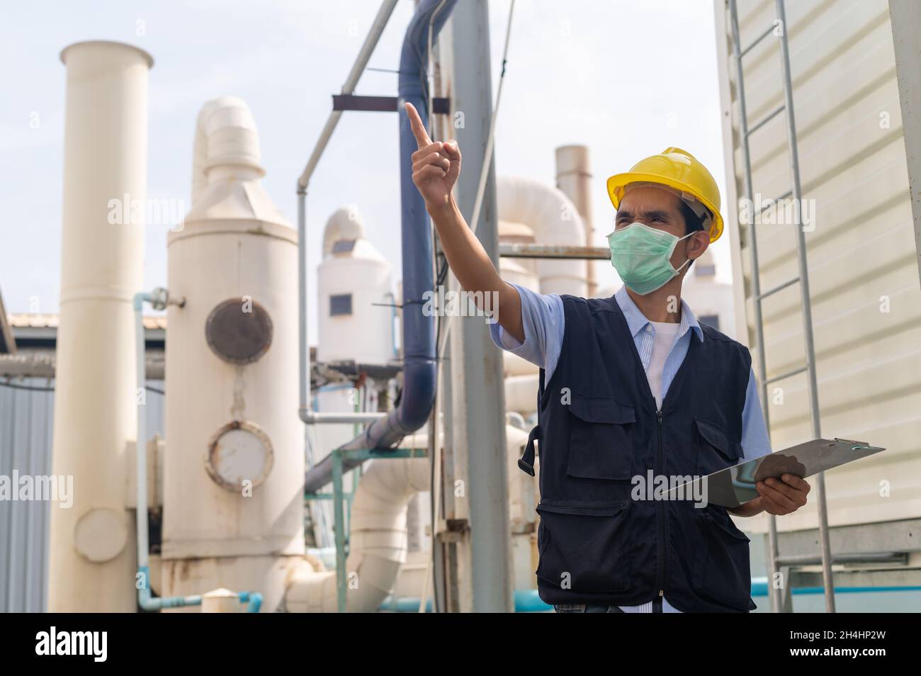 Safety Manager checking power plant system in factory Stock Photo - Alamy