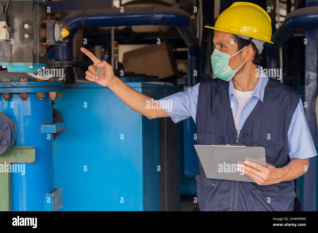 Engineers monitor the operation of industrial machinery and control ...