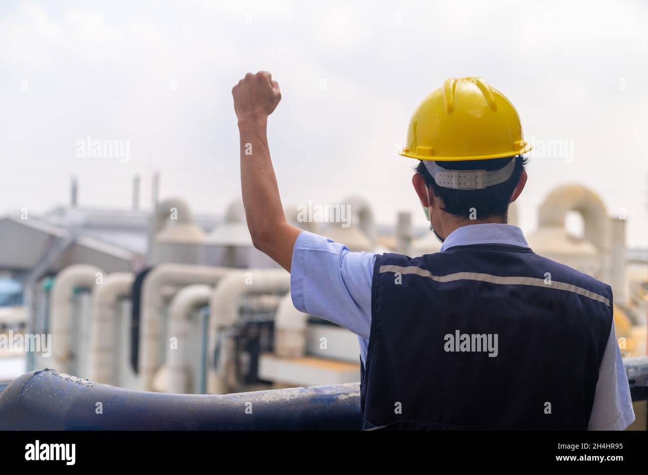 Engineer standing on the roof of the production building Show ...