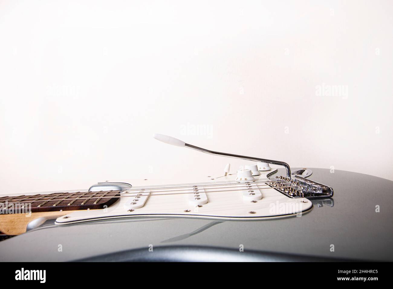 Silver electric guitar isolated on white background Stock Photo - Alamy
