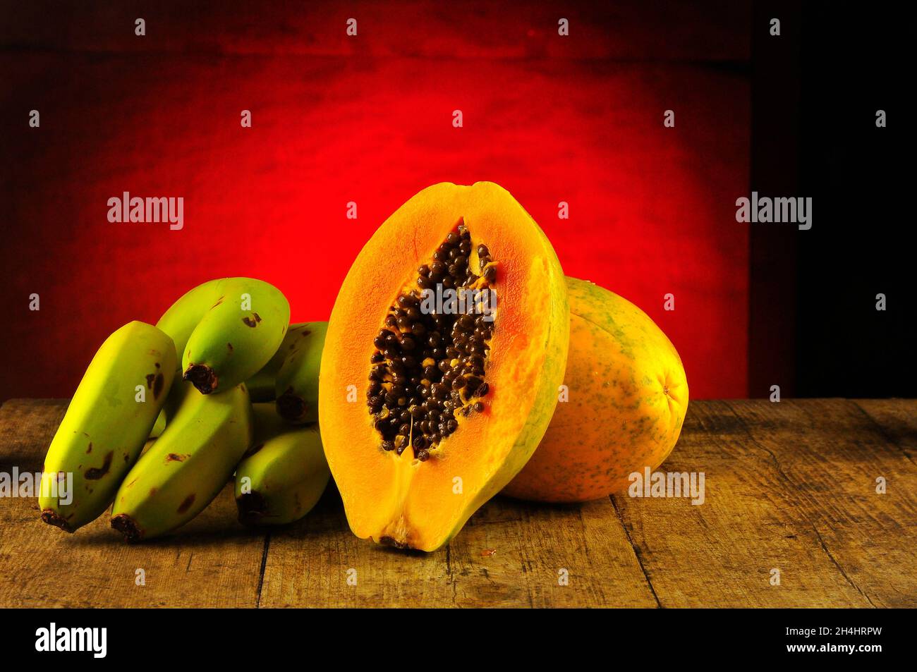 Fruits on wodden table .red gradient Stock Photo - Alamy