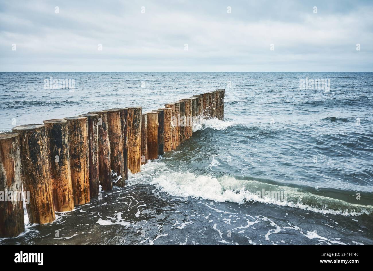 Wooden breakwater seen from a beach, color toning applied Stock Photo ...