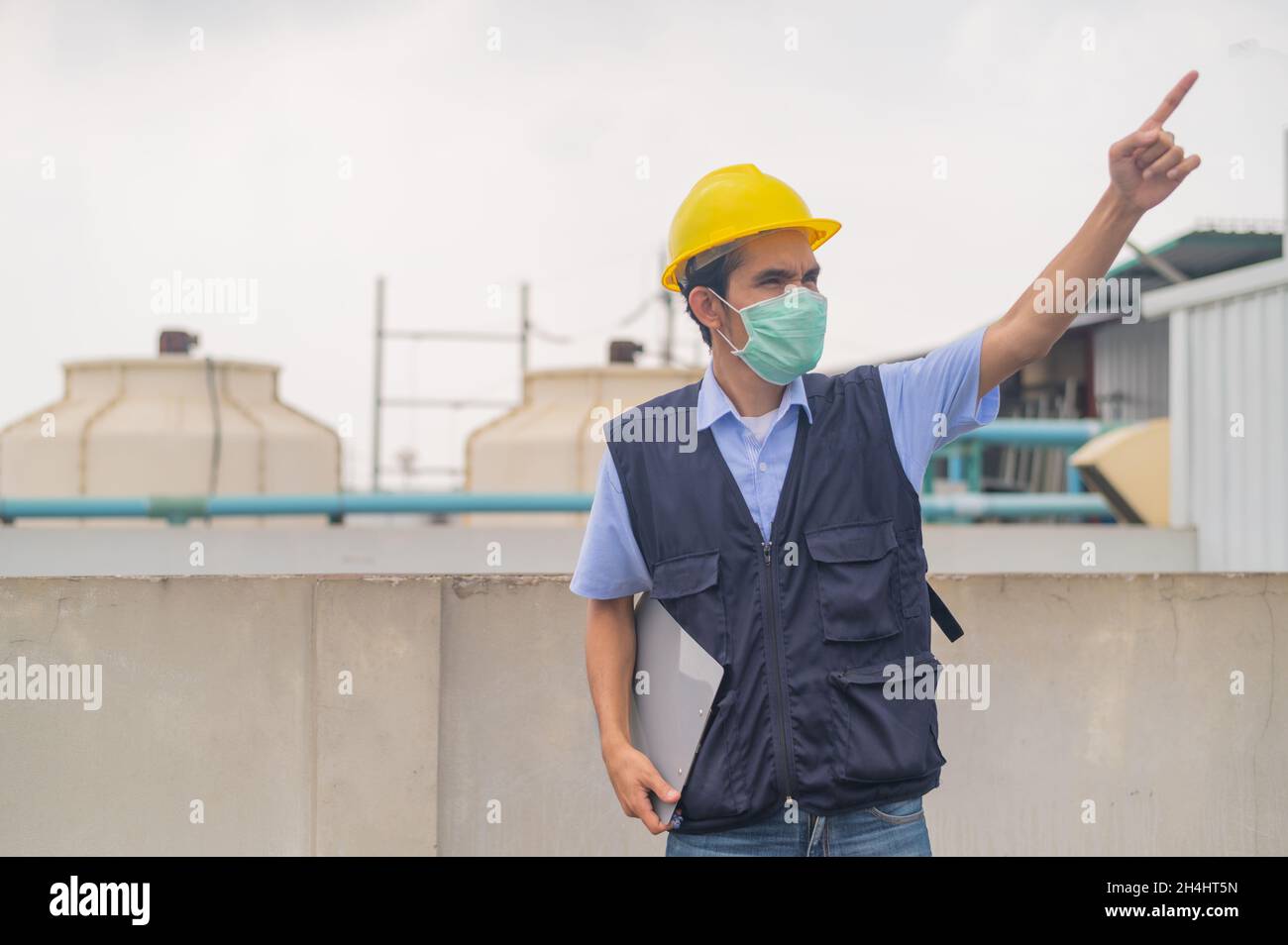 Engineer standing on the roof of the production building Show ...