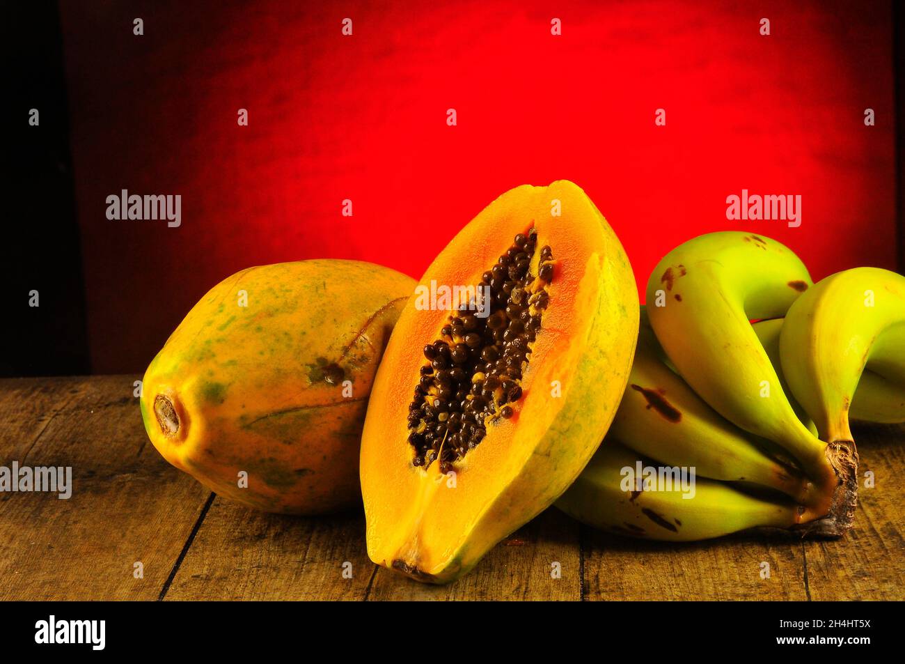 Fruits on wodden table .red gradient Stock Photo - Alamy