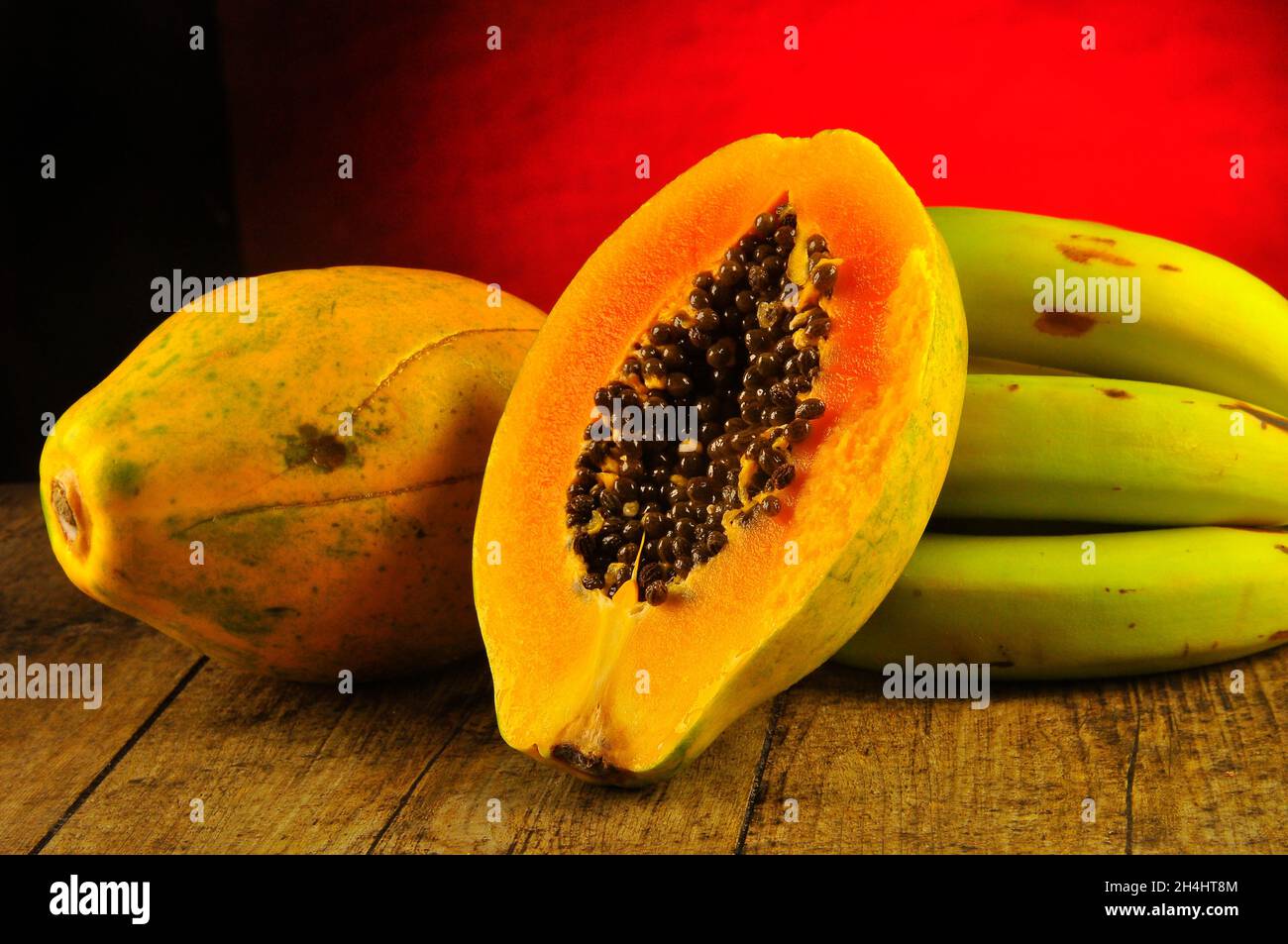 Fruits on wodden table .red gradient Stock Photo - Alamy