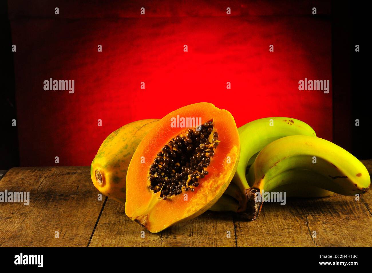 Fruits on wodden table .red gradient Stock Photo - Alamy