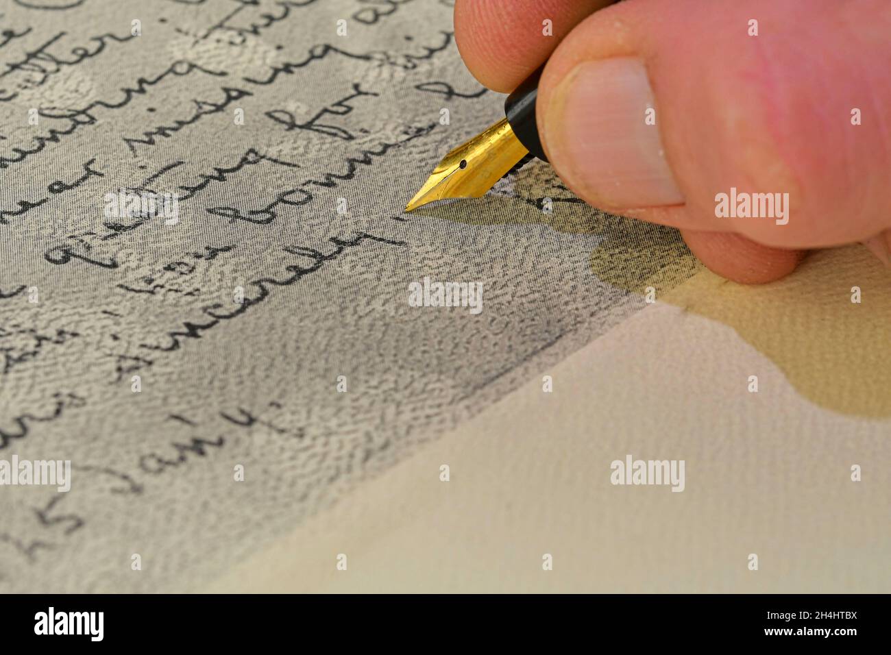 Close-up of a male hand ready to write with an elegant fountain pen ...