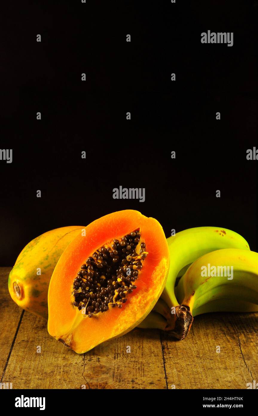 Fruits on wodden table .red gradient Stock Photo - Alamy