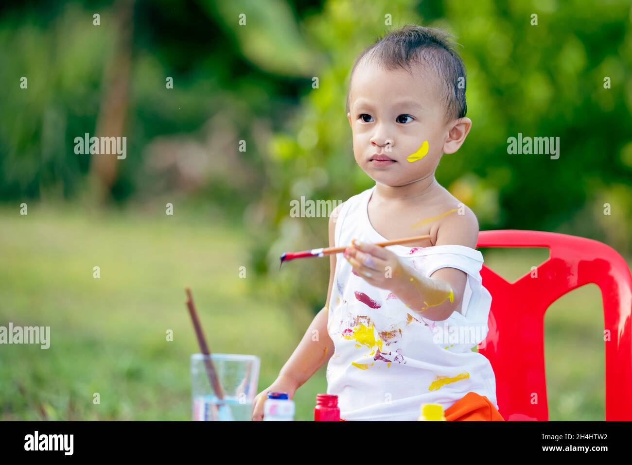 Kid Painting. Happy little cute child girl with dirty hands and fingers ...