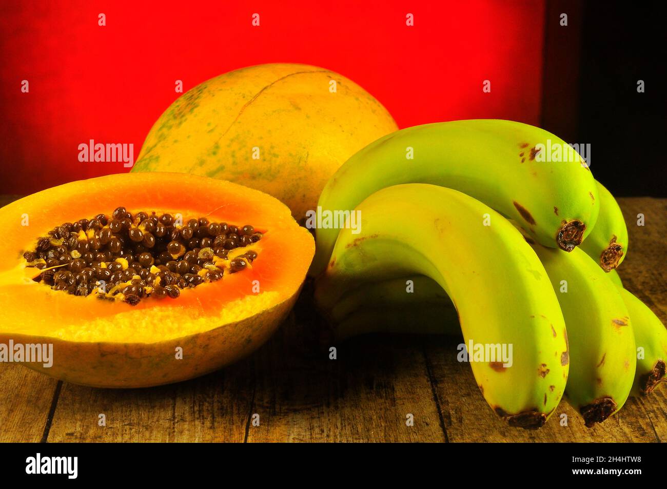 Fruits on wodden table .red gradient Stock Photo - Alamy