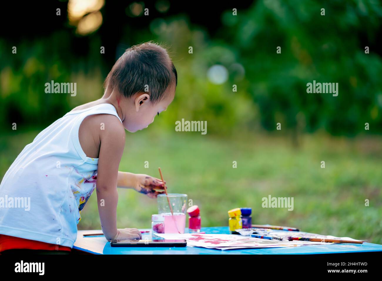 Kid Painting. Happy little cute child girl with dirty hands and fingers ...
