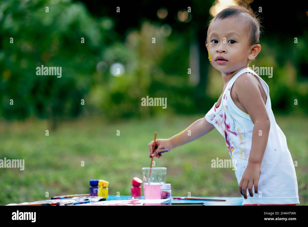 Kid Painting. Happy little cute child girl with dirty hands and fingers ...