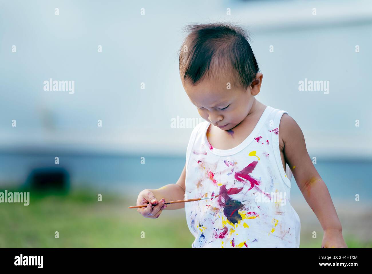 Kid Painting. Happy little cute child girl with dirty hands and fingers ...