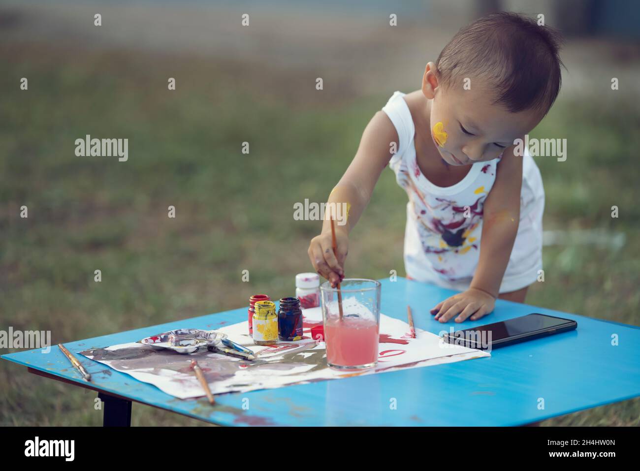 Kid Painting. Happy little cute child girl with dirty hands and fingers ...