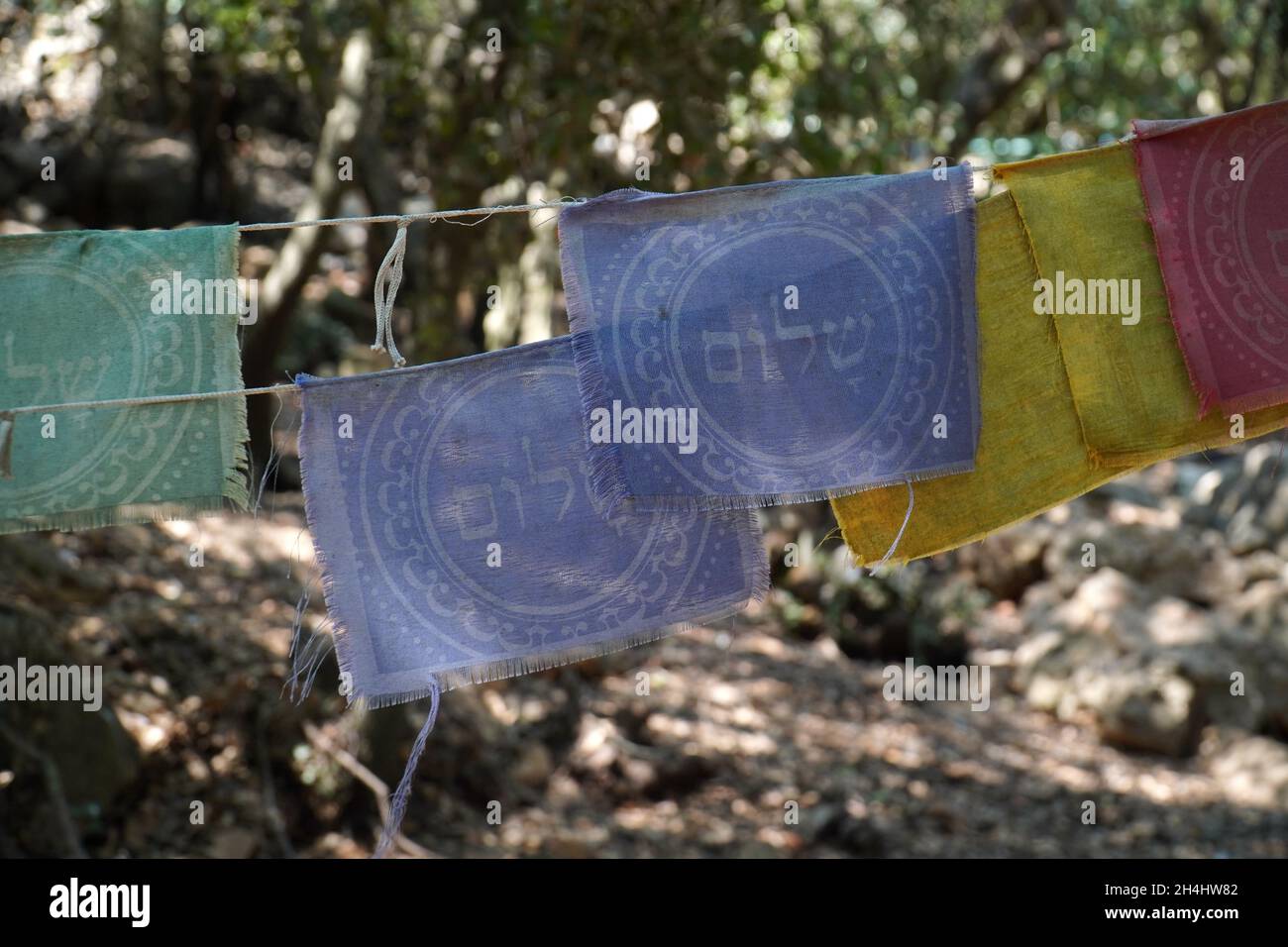 Prayer flags with word "shalom" written on them in Hebrew with the ...