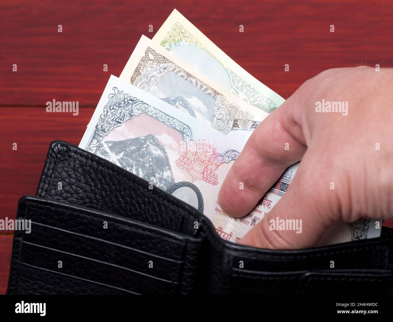 Nepalese money - rupee in the black wallet Stock Photo - Alamy