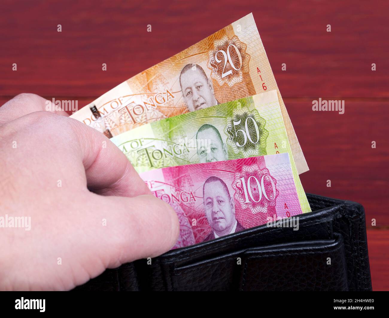Tongan money - paʻanga in the black wallet Stock Photo - Alamy