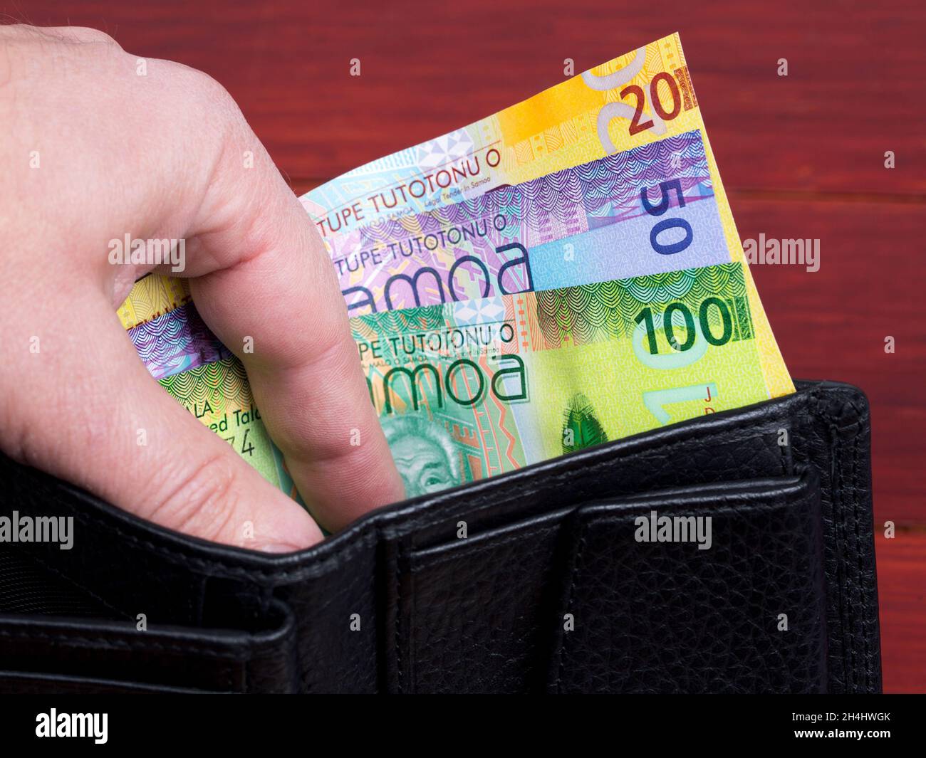 Samoan money - tala in the black wallet Stock Photo - Alamy