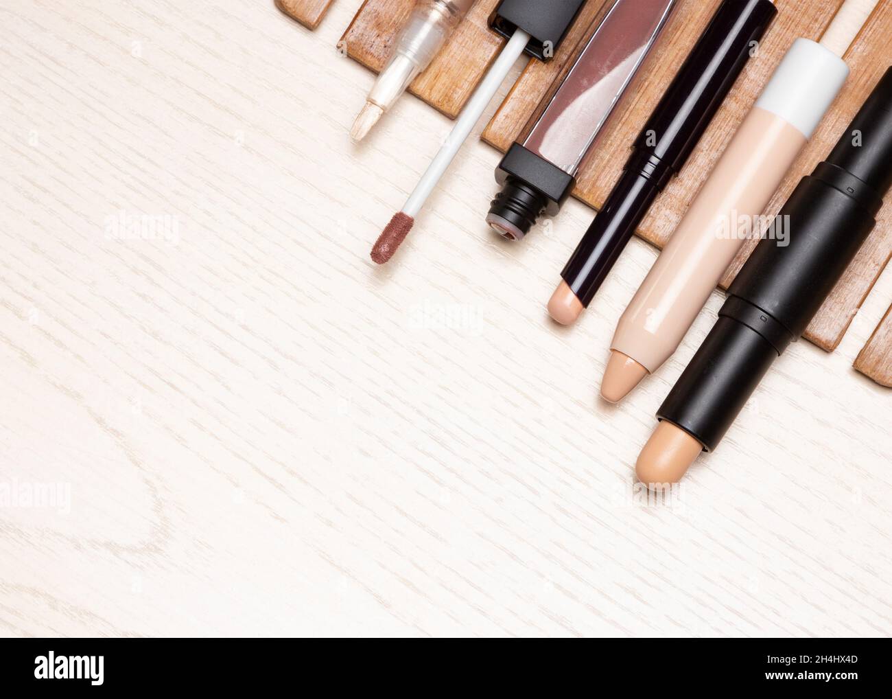 Different types of make-up concealers on white wooden table. Diagonal ...