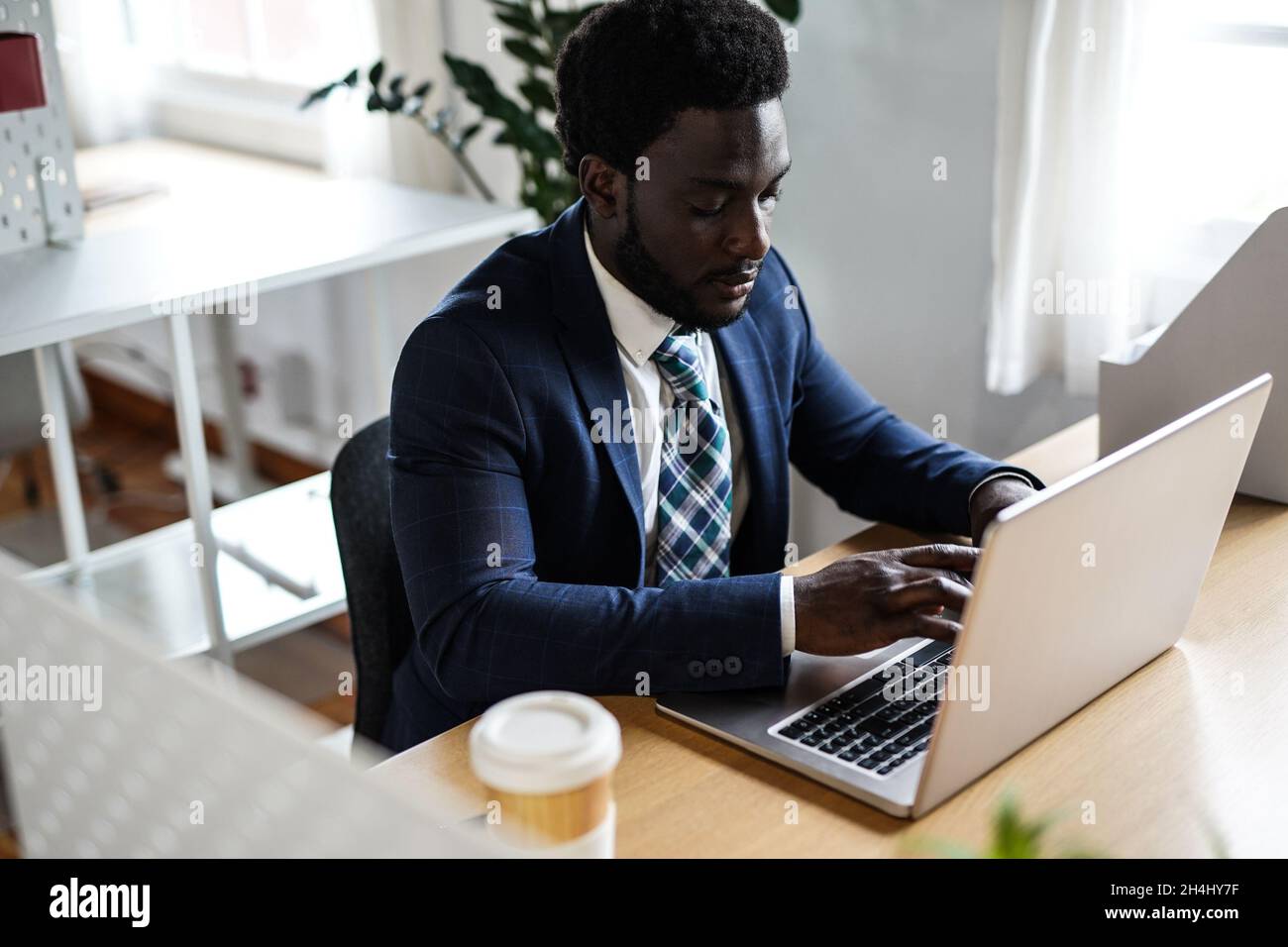 Business african man working inside modern office using computer laptop ...