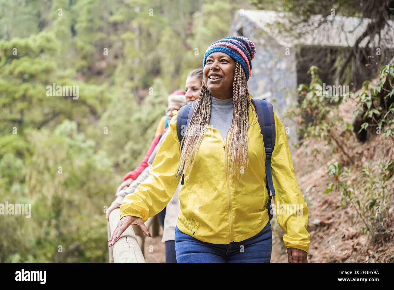 Multiracial women having fun exploring nature on trekking day in to the ...