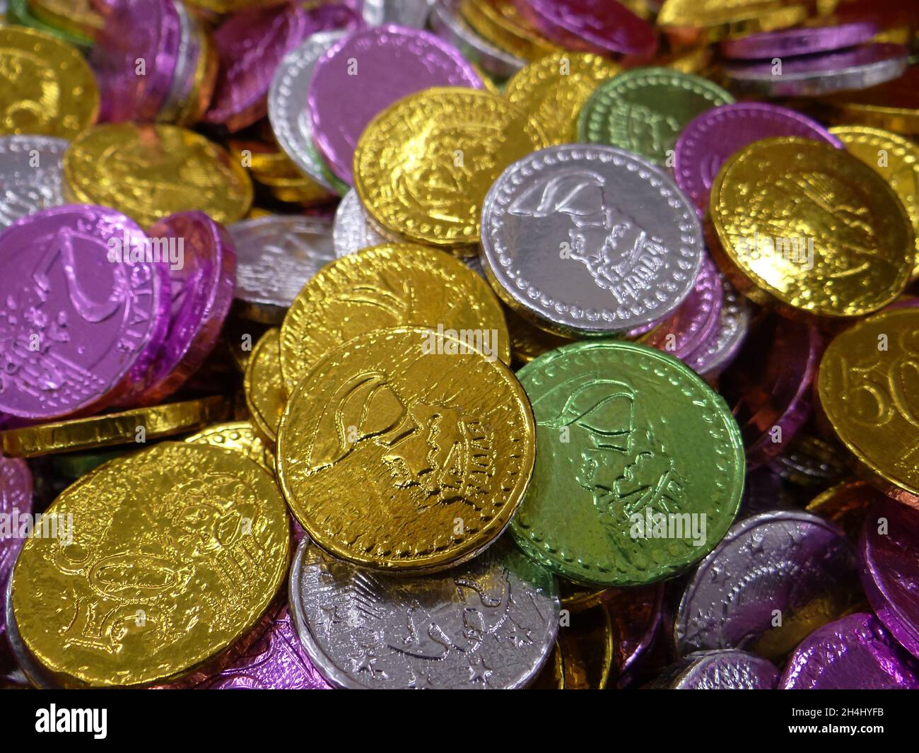 Close-up shot of a pile of colorful round coin chocolate candies ...