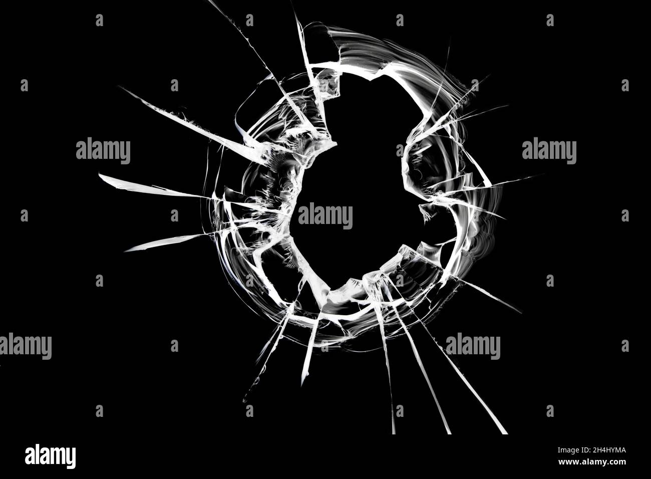 The glass hole shatters on the window from a bullet shot. Broken glass ...