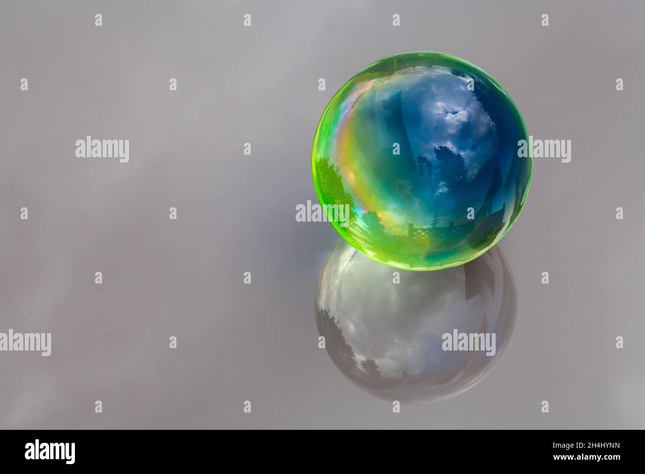 Colored glass ball with mirrors and reflective background Stock Photo ...