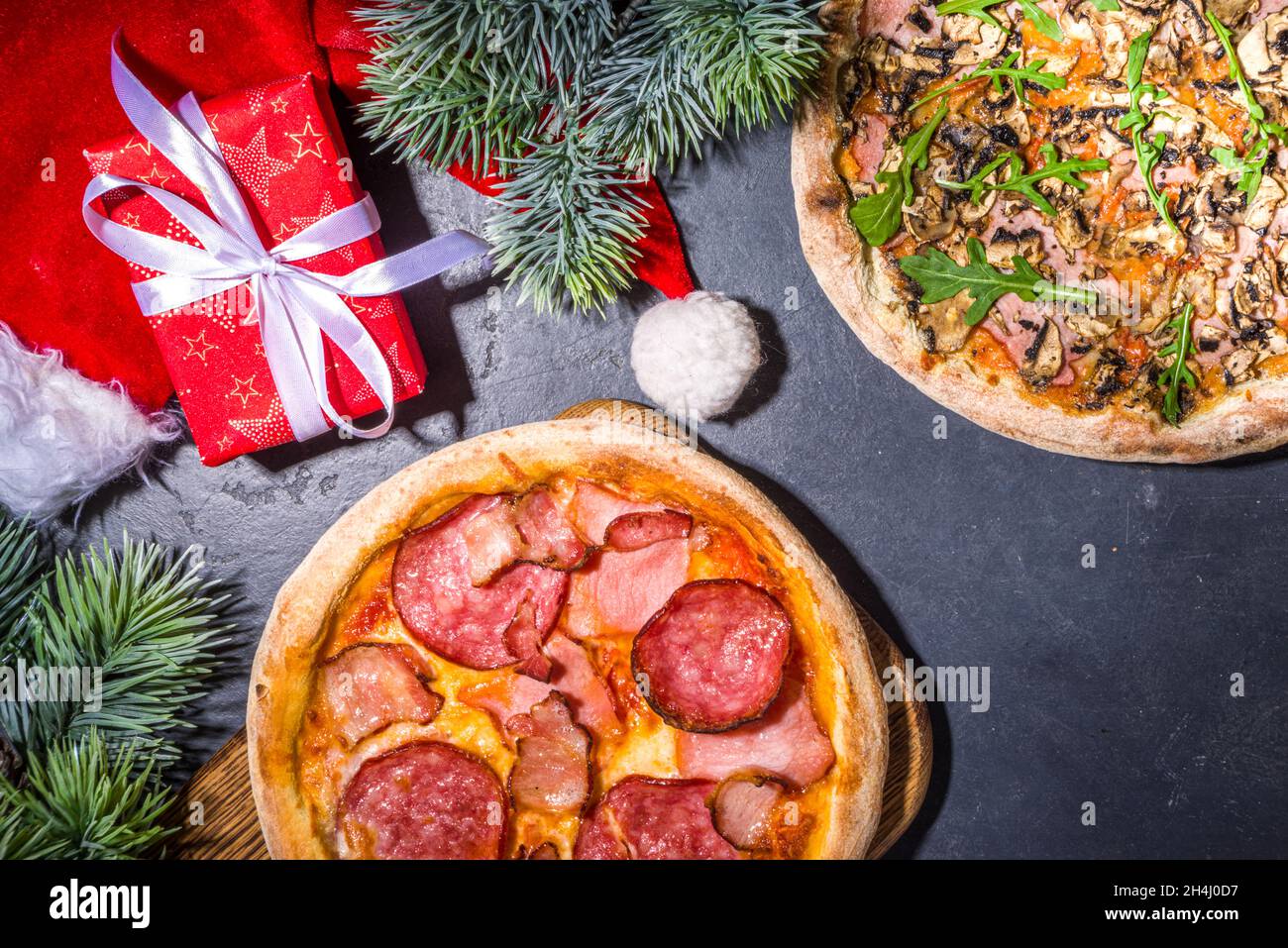 Christmas decorated background with pepperoni and mushrooms pizza ...