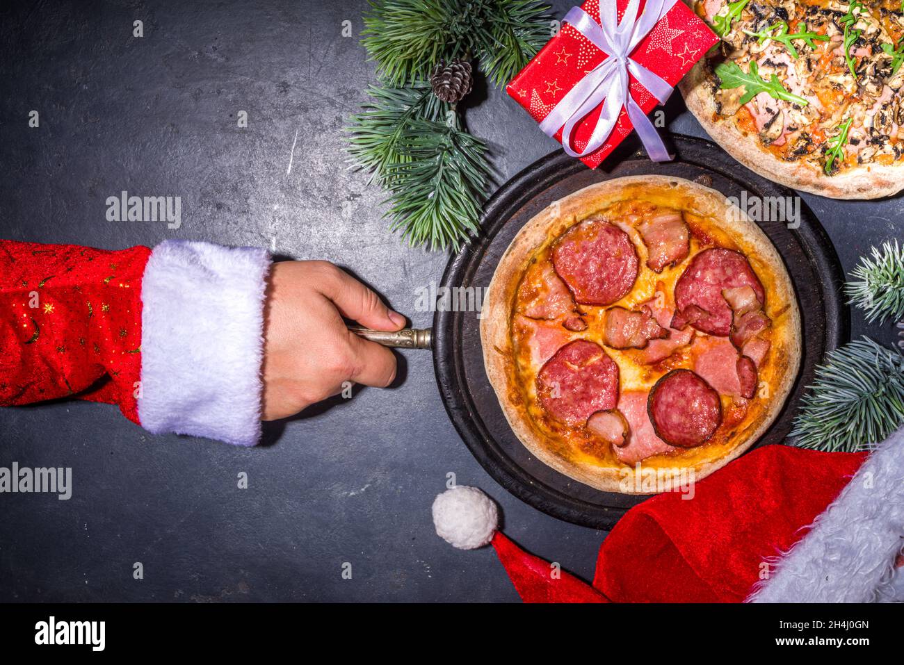 Christmas decorated background with pepperoni and mushrooms pizza,with ...