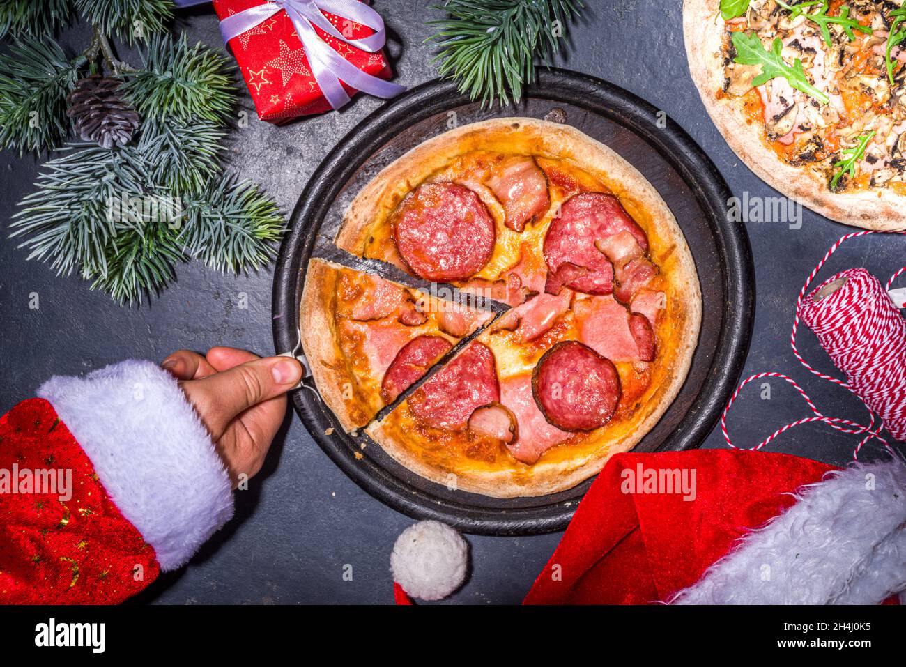 Christmas decorated background with pepperoni and mushrooms pizza,with ...